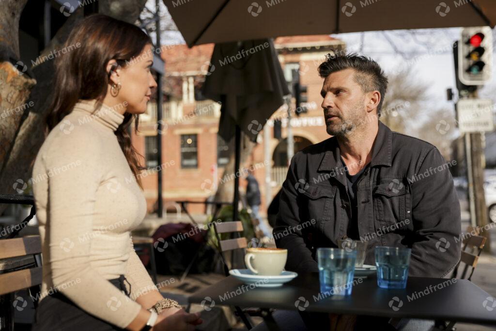 Two people talking, sitting outside at a cafe – Mindframe online image ...