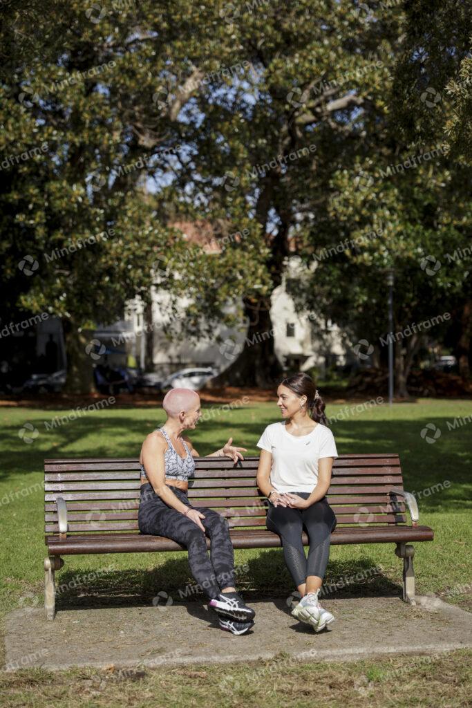 Two people talking, sitting on a park bench – Mindframe online image ...