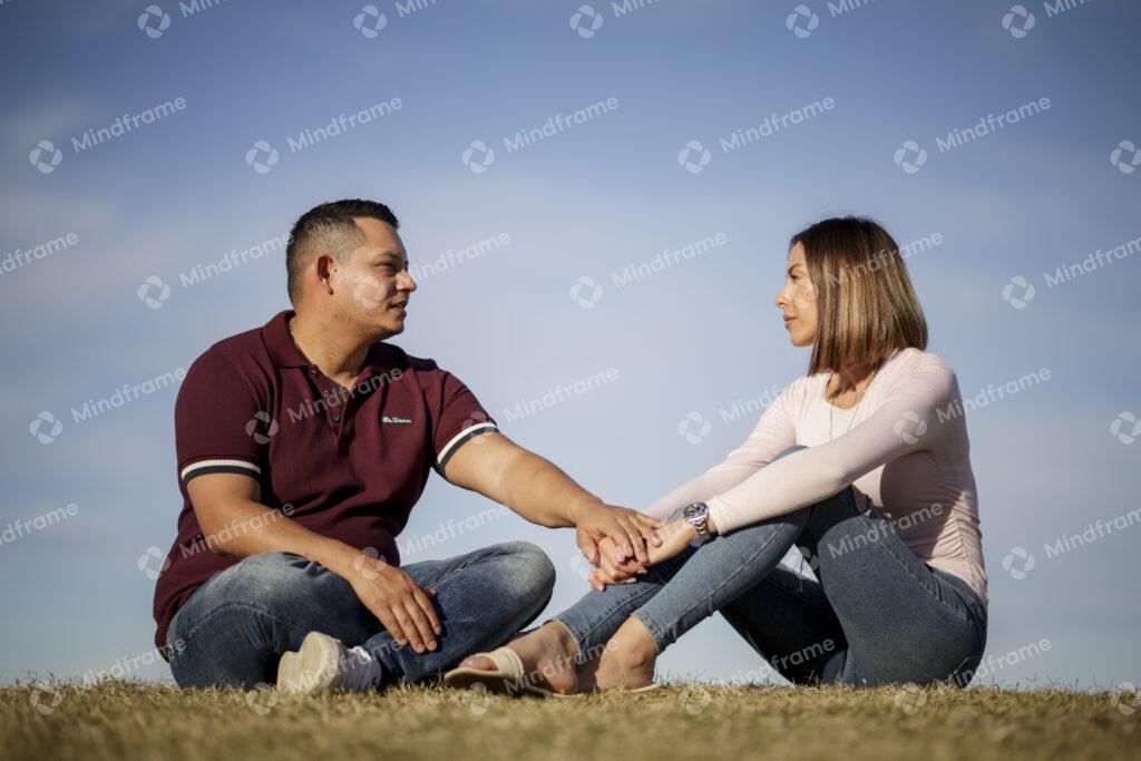 Two people sitting outside holding hands – Mindframe online image ...