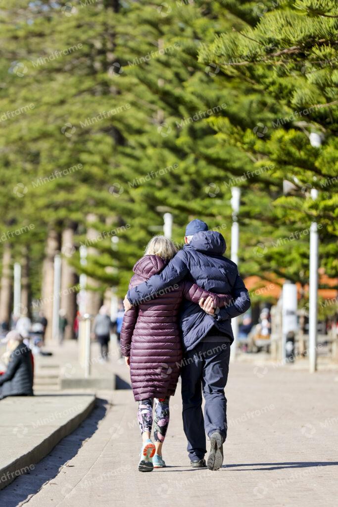 Two people walking in arms along path – Mindframe online image collection