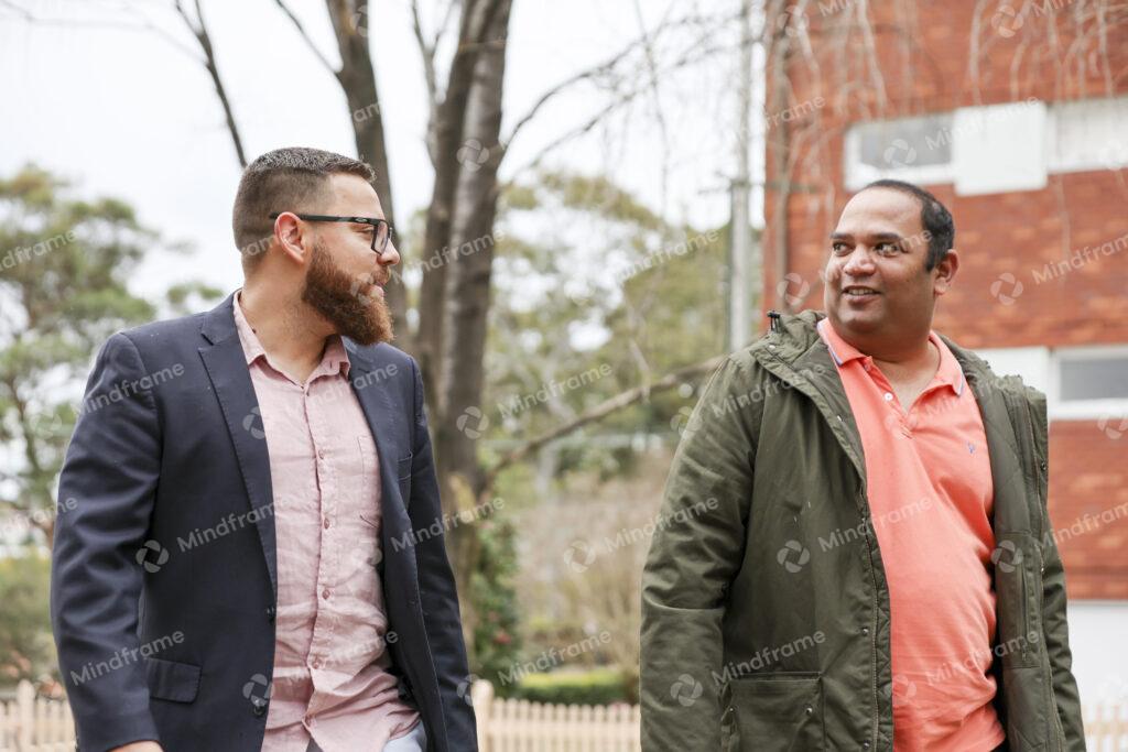 Two people talking and walking outside in front of units – Mindframe ...