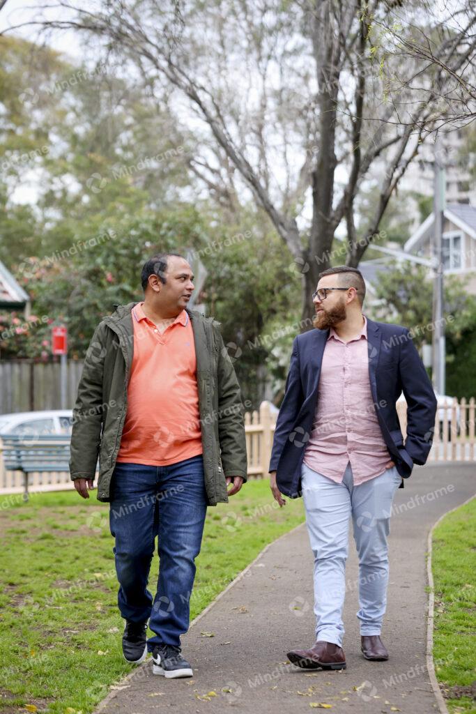 Two people talking and walking outside in park – Mindframe online image ...