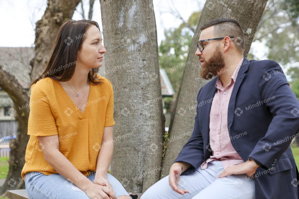 Two people talking sitting in front of a tree – Mindframe online image ...