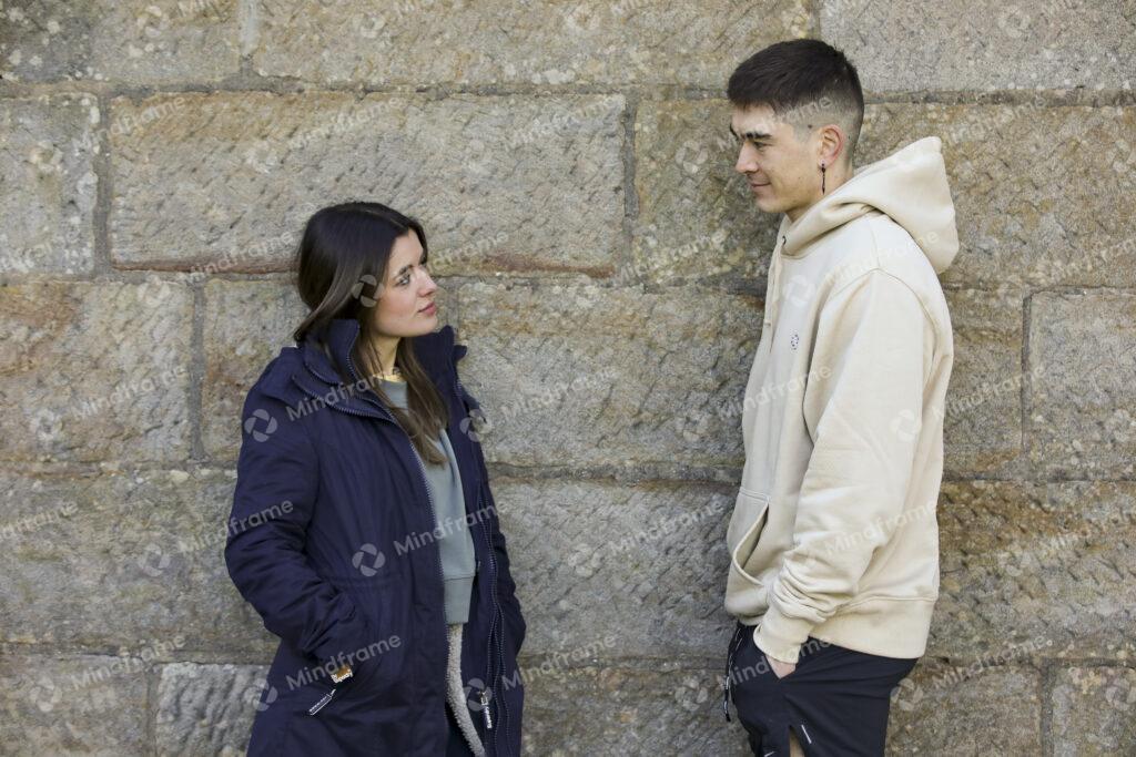 Two people talking and standing in front of wall – Mindframe online ...