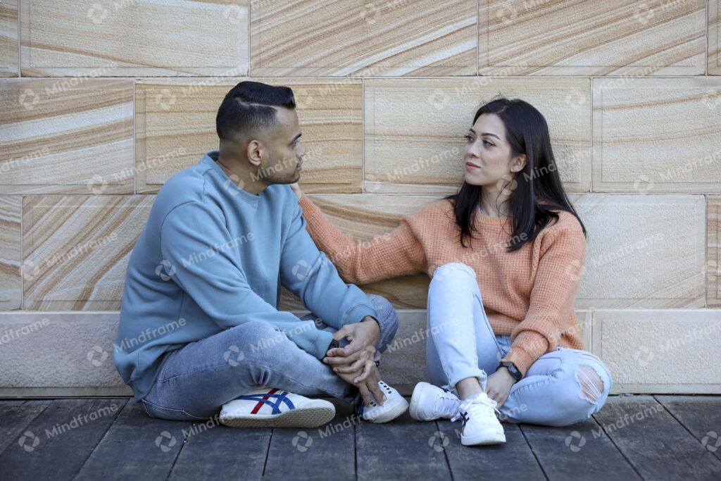 Two people sitting on the ground together – Mindframe online image ...