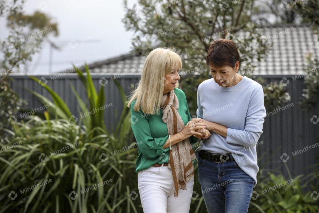 Two people standing and talking in the garden – Mindframe online image ...