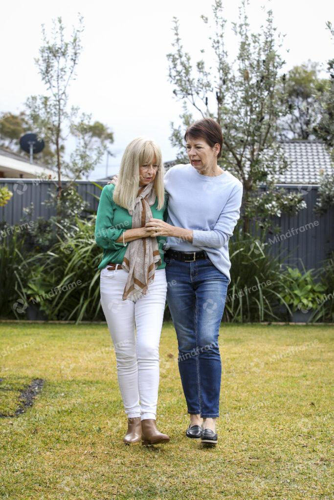 Two people standing and talking in the garden – Mindframe online image ...