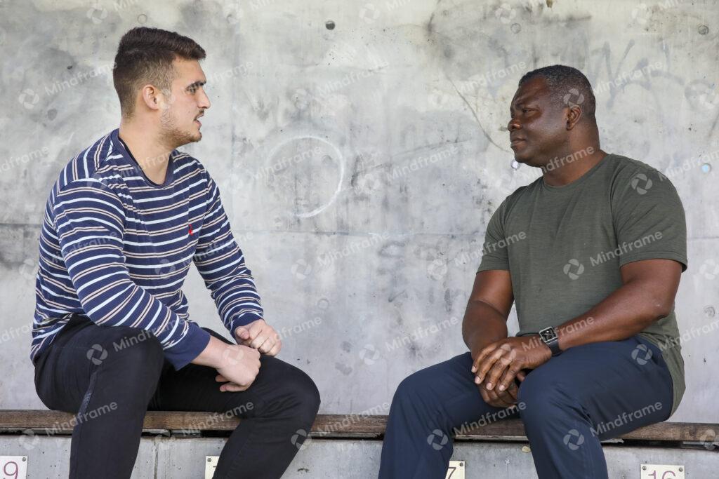 Two people talking sitting on a bench – Mindframe online image collection