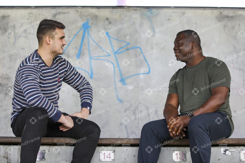 Two people talking sitting on a bench – Mindframe online image collection