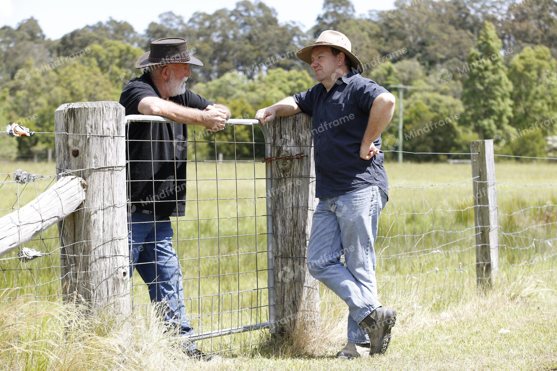 Two people leaning on a paddock gate at a farm – Mindframe online image ...