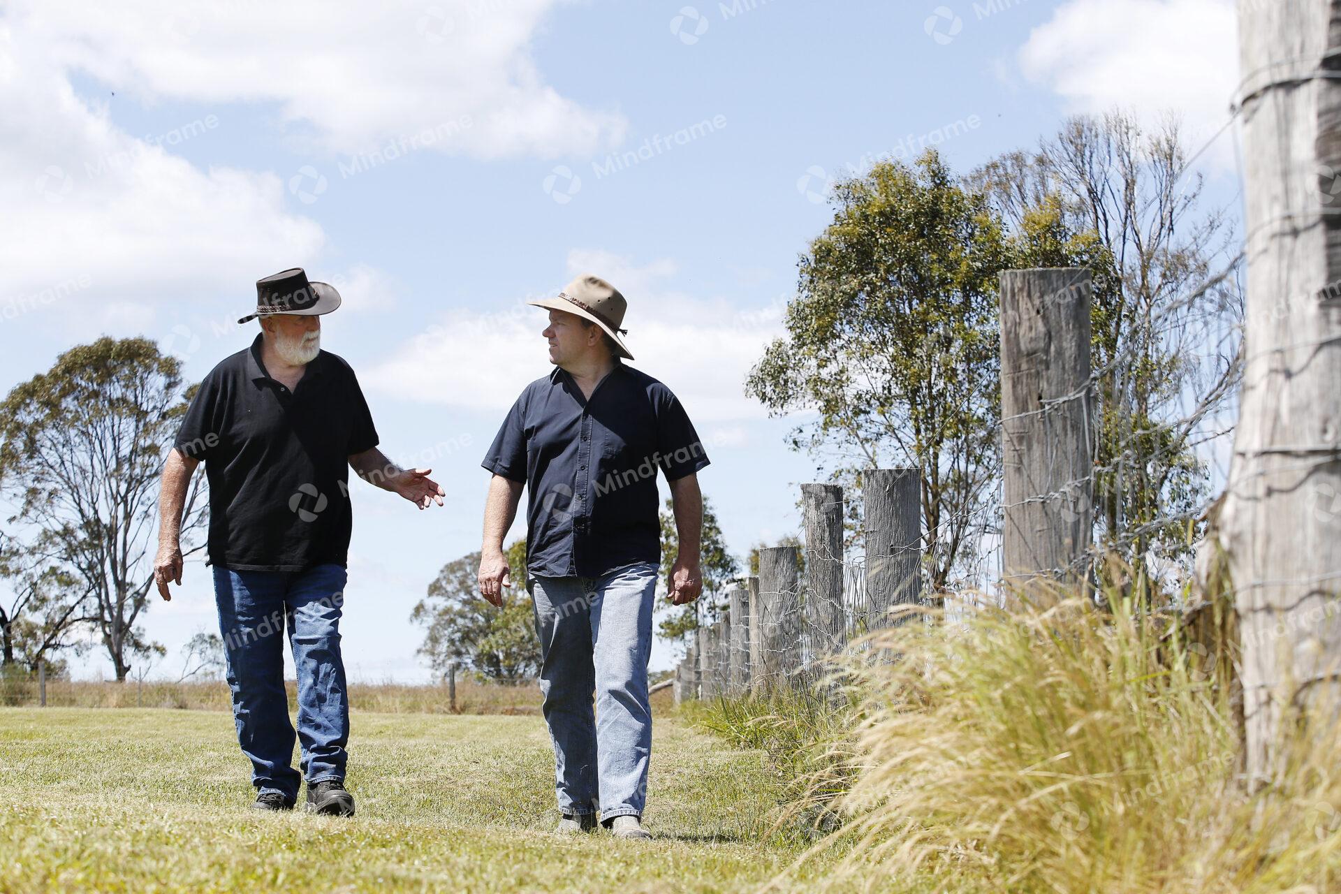 Twp people walking by a paddock fence at a farm – Mindframe online ...