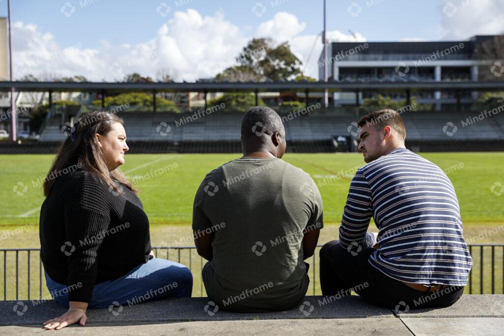 Three people talking outside in the sun – Mindframe online image collection