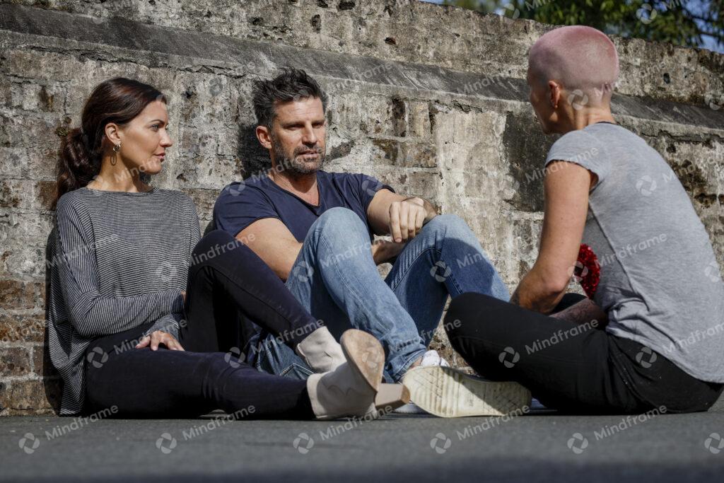 Three people sitting and talking, outside – Mindframe online image ...